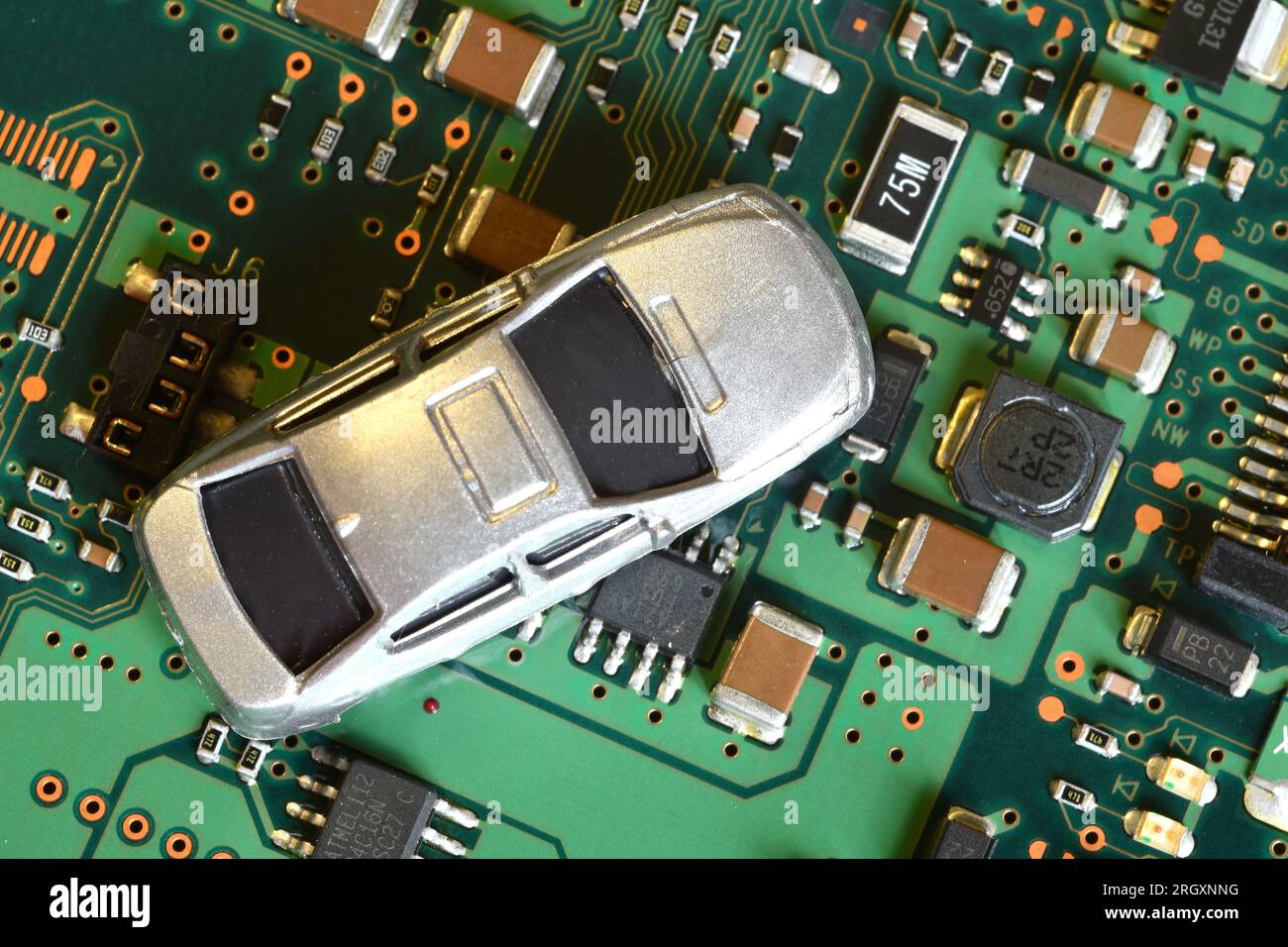 Toy cars on electronic board and microchip. Conceptual image for ...