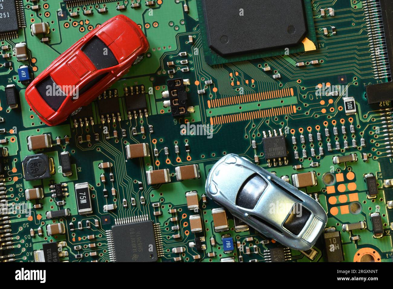 Toy cars on electronic board and microchip. Conceptual image for ...