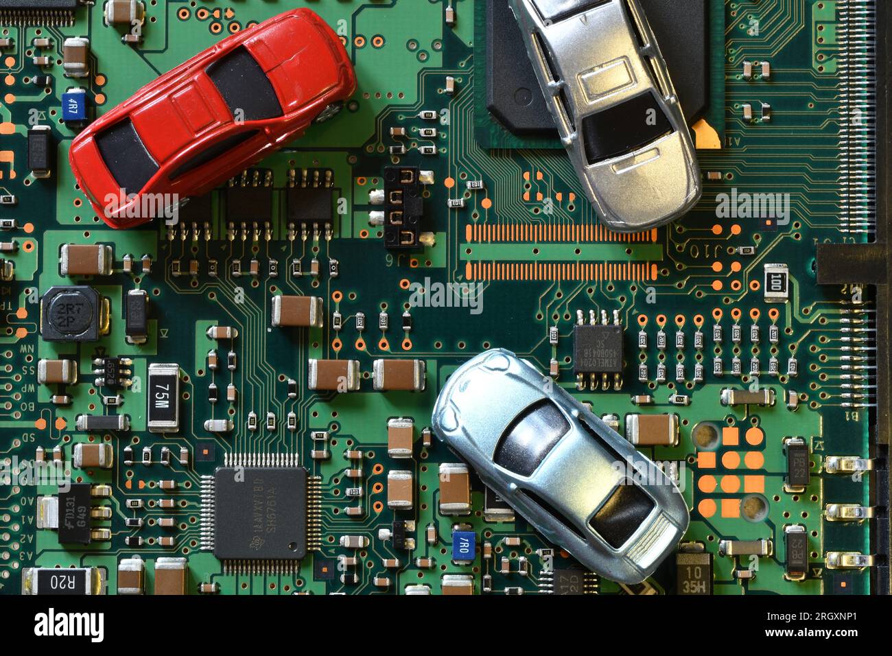 Toy cars on electronic board and microchip. Conceptual image for ...