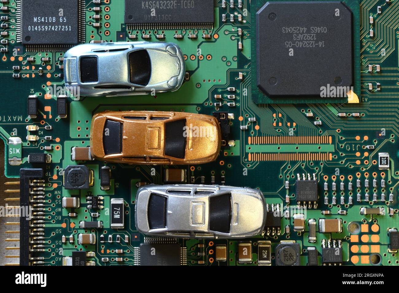 Toy cars on electronic board and microchip. Conceptual image for ...
