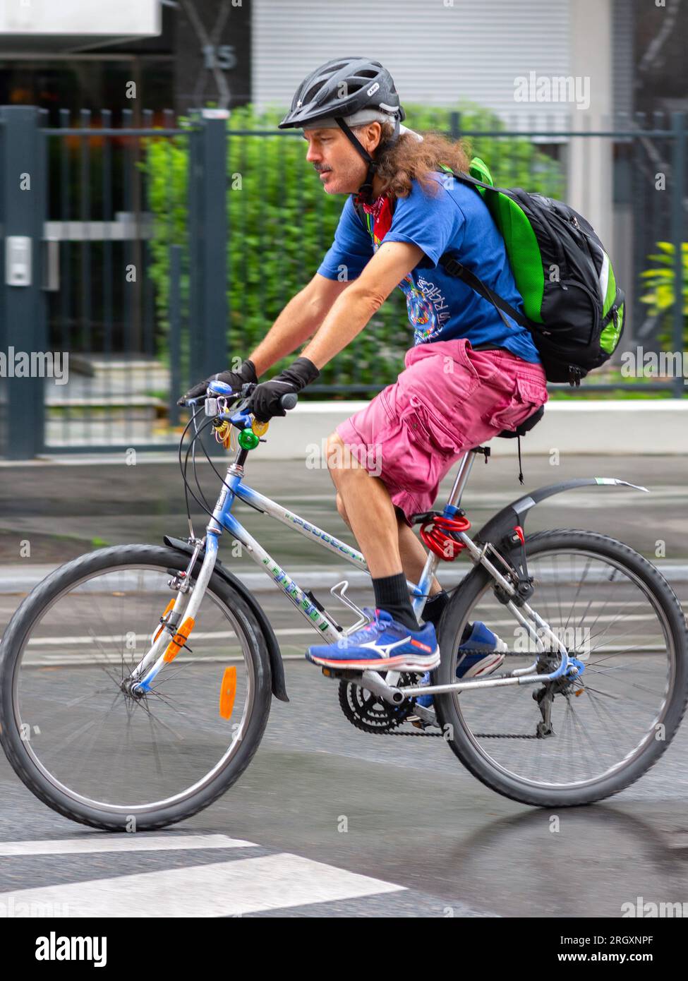 Casually dressed male riding cycle in city center - Paris 16 France ...