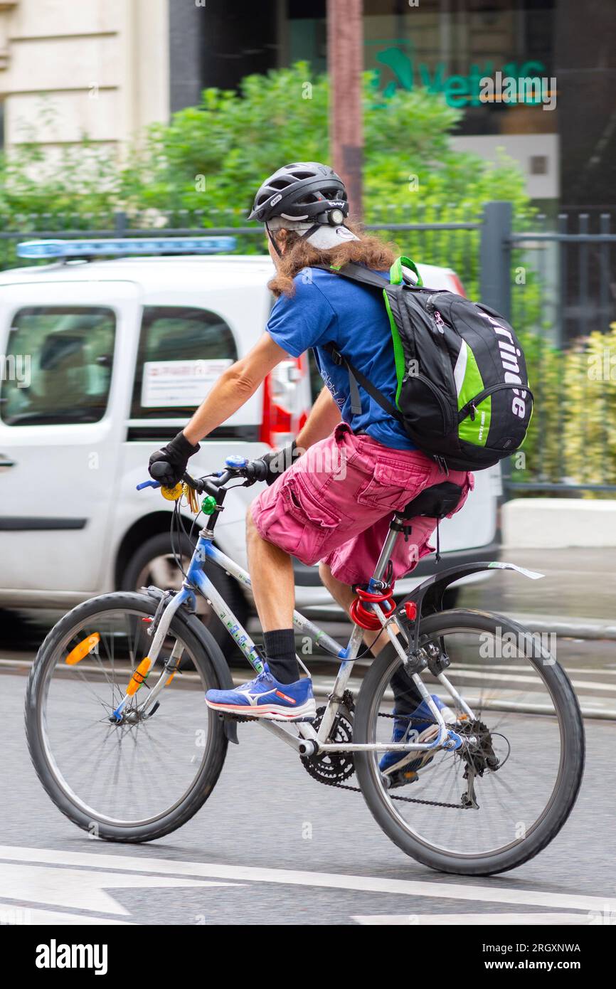 Casually dressed male riding cycle in city center - Paris 16 France ...
