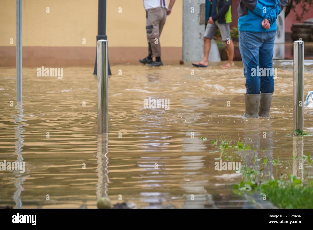 People in floods at city streets after heavy rain. Severe weather ...