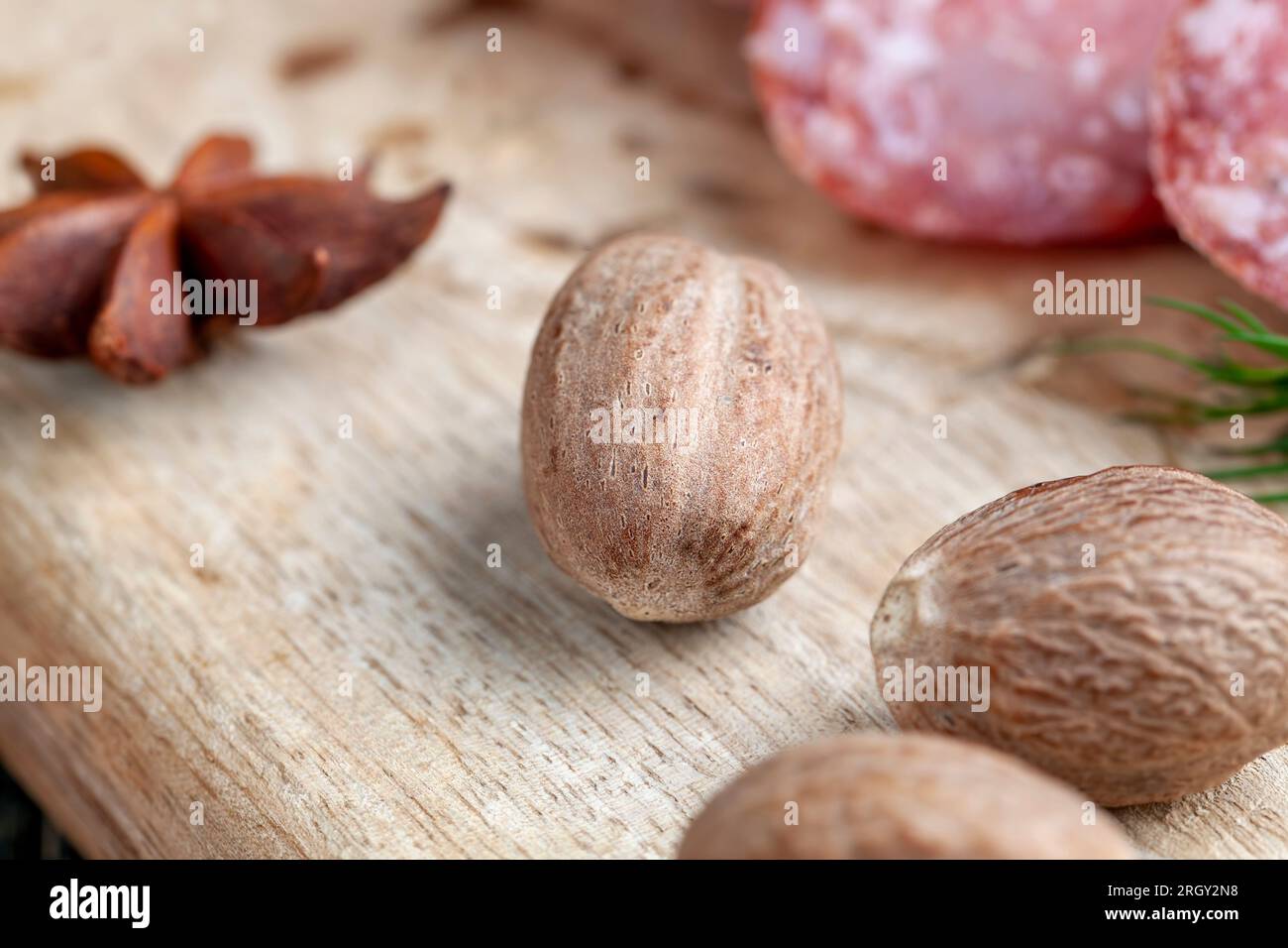 a whole nutmeg on a wooden board, a whole nutmeg that is used in ...