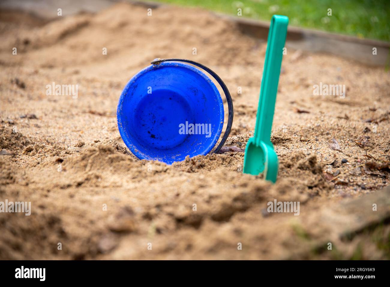 close up of plastic toy bucket and spade in sandbox Stock Photo - Alamy