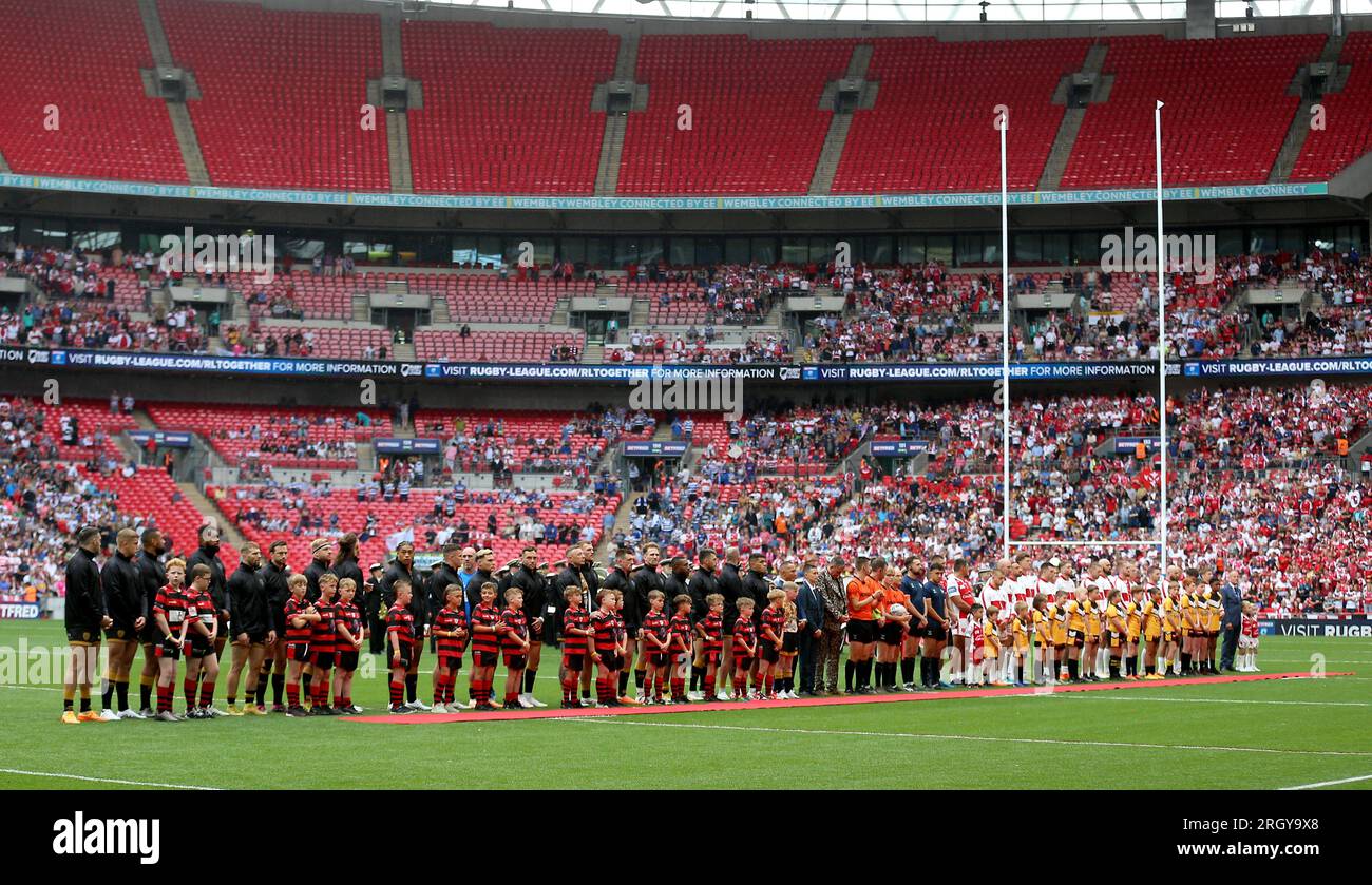 The players line up for the national anthem before the Betfred ...