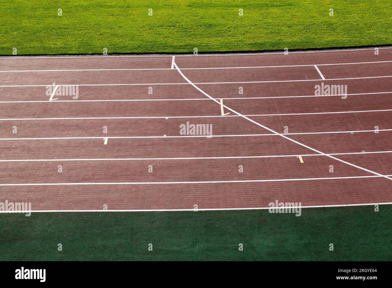 the red surface of the old running track at the stadium, the running ...