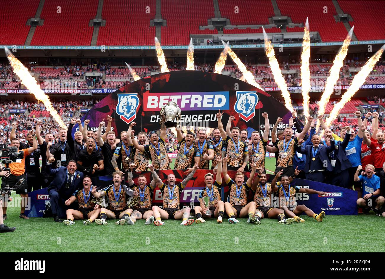 Leigh Leopards' players celebrate with the trophy on the pitch after ...