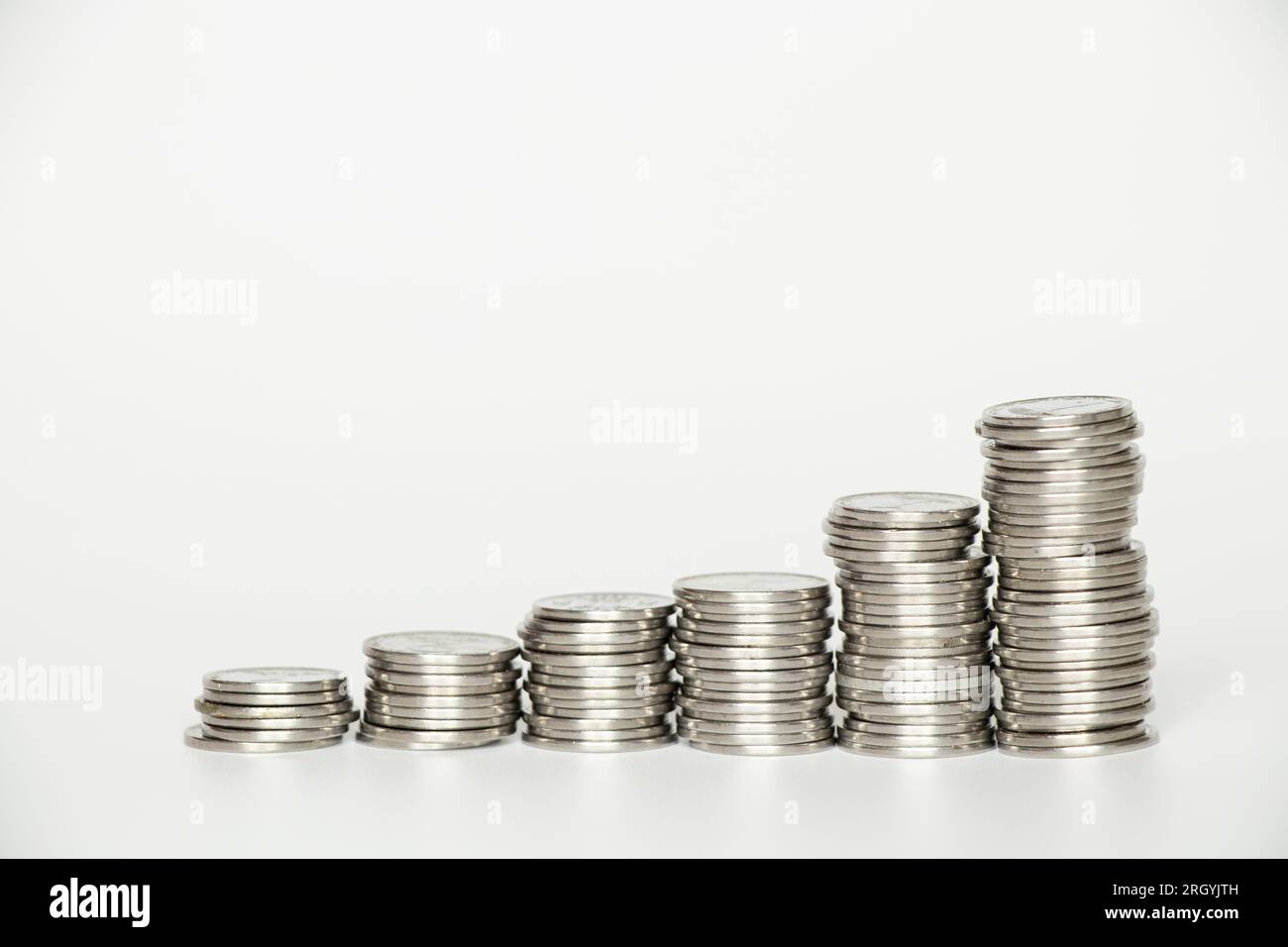 Stacks of coins stand on a white background, business and finance Stock ...