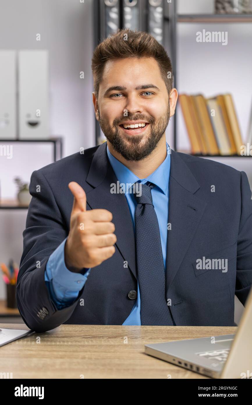 Like. Happy young businessman guy working on laptop looking approvingly ...