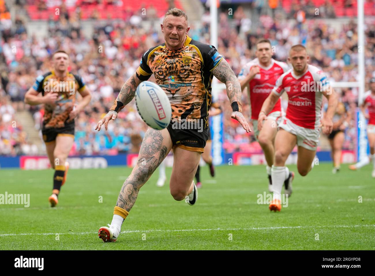 Josh Charnley #5 of Leigh Leopards chases a loose ball during the ...