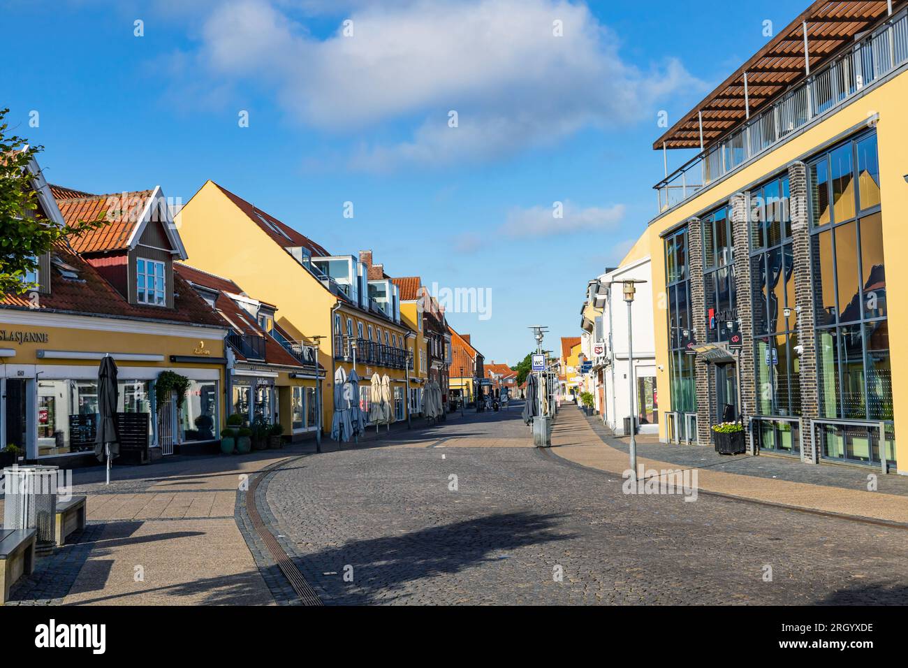 Skagen city street with traditional yellow houses and restaurants ...