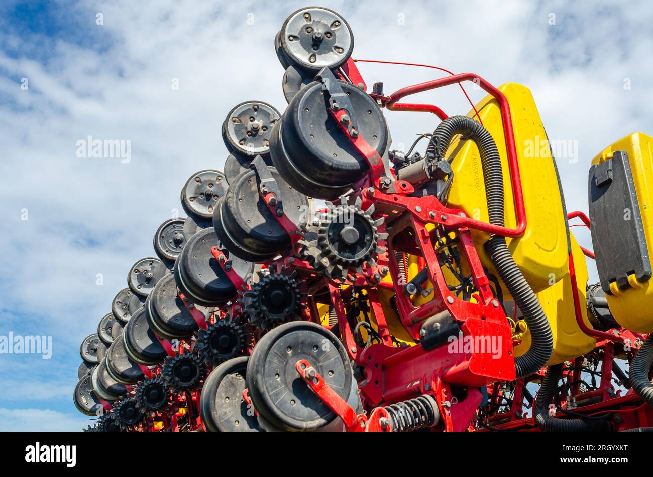 Parts and mechanisms of agricultural machinery on background of blue ...