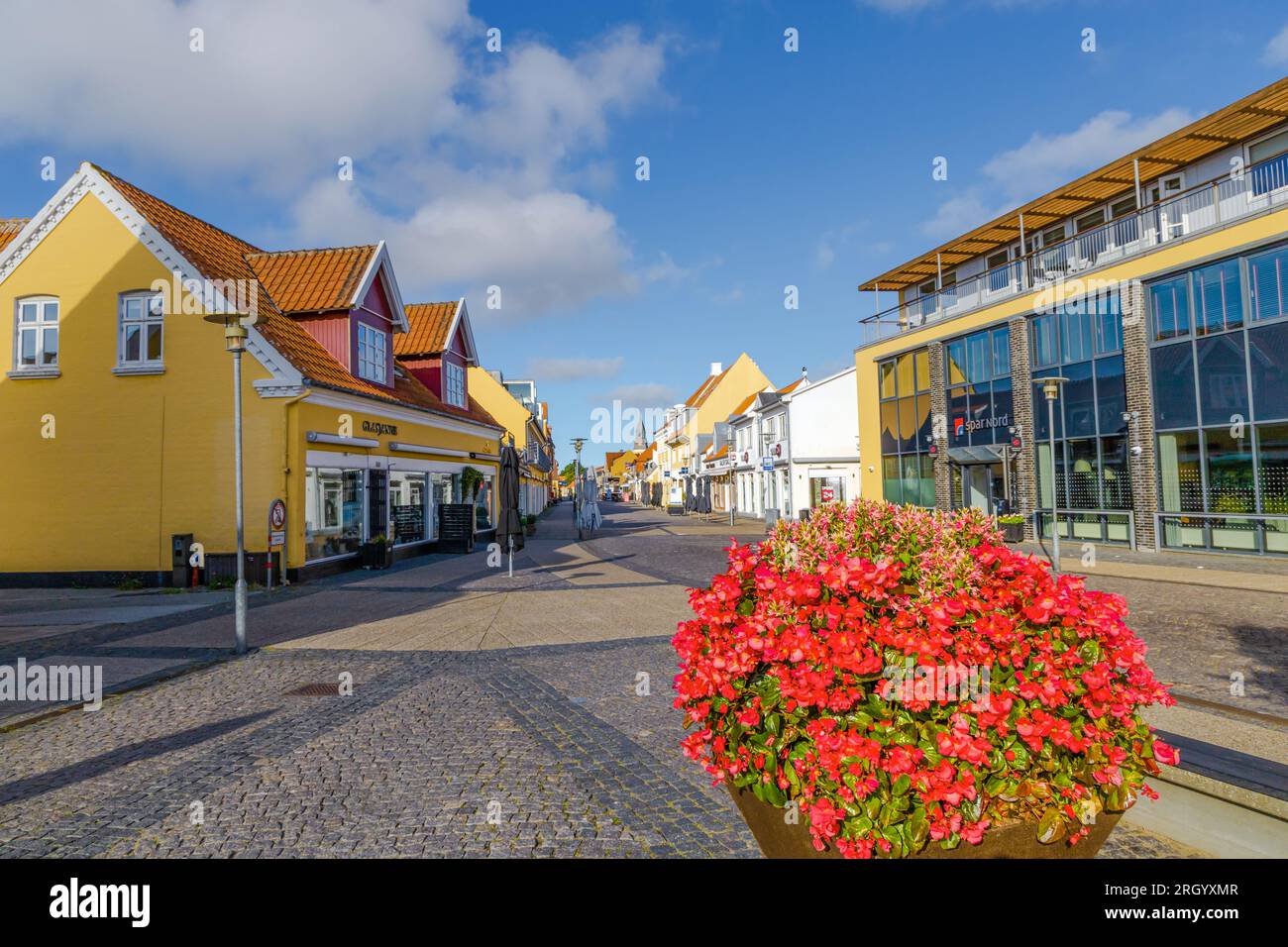 Skagen city street with traditional yellow houses and restaurants ...