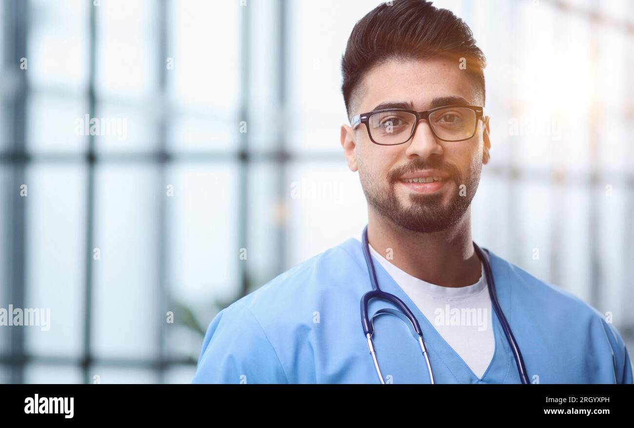 Focused on saving lives. Portrait of young male doctor standing in a ...