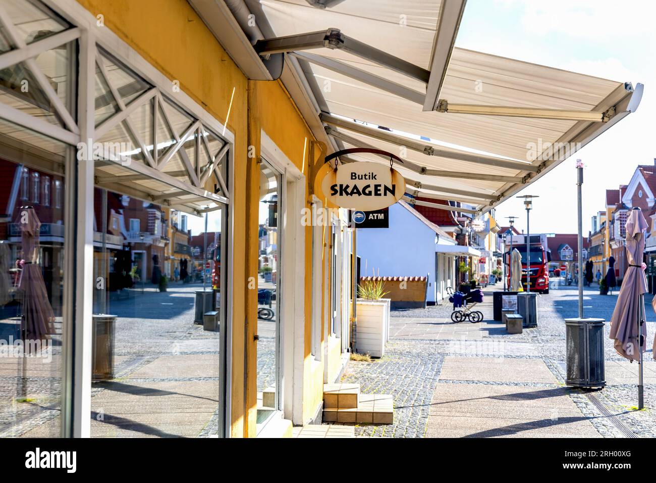 Skagen city street with traditional yellow houses and restaurants ...