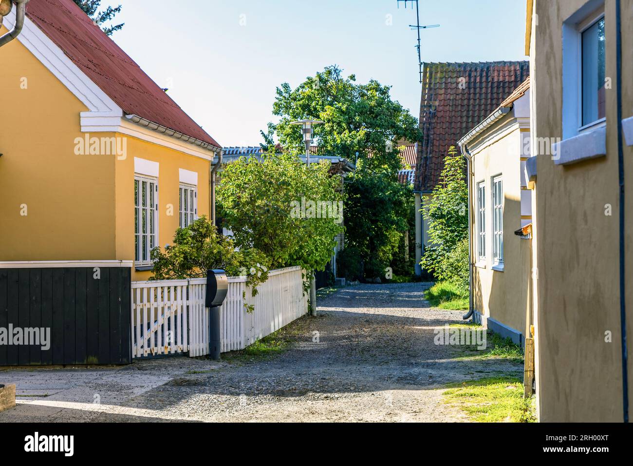 Skagen city street with traditional yellow houses and restaurants ...