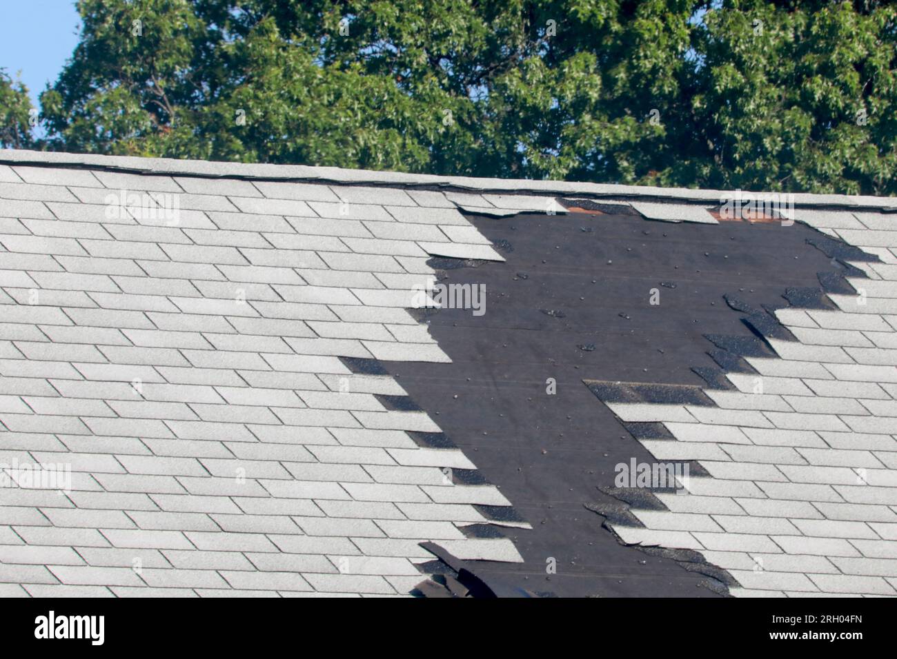 Damaged roof with missing shingles Stock Photo - Alamy
