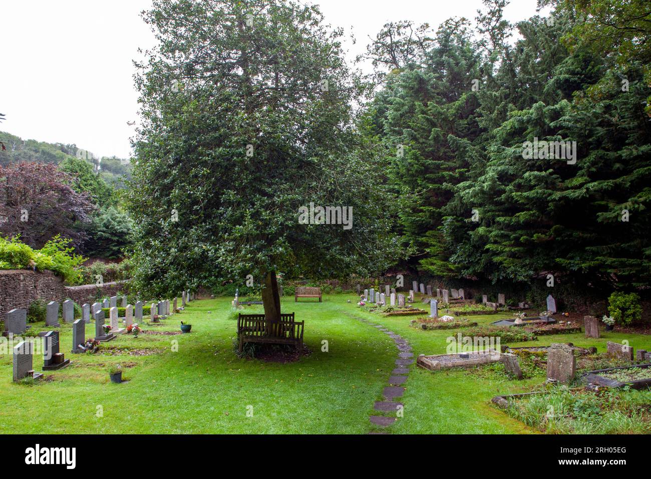 Graves in the cemetery at St Andrew's Church, Castle Combe Village in ...