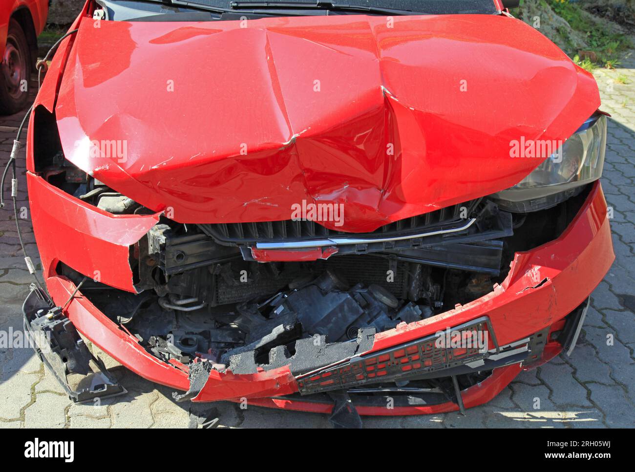 Crashed car of red color. Front view of the wrecked vehicle. The car ...