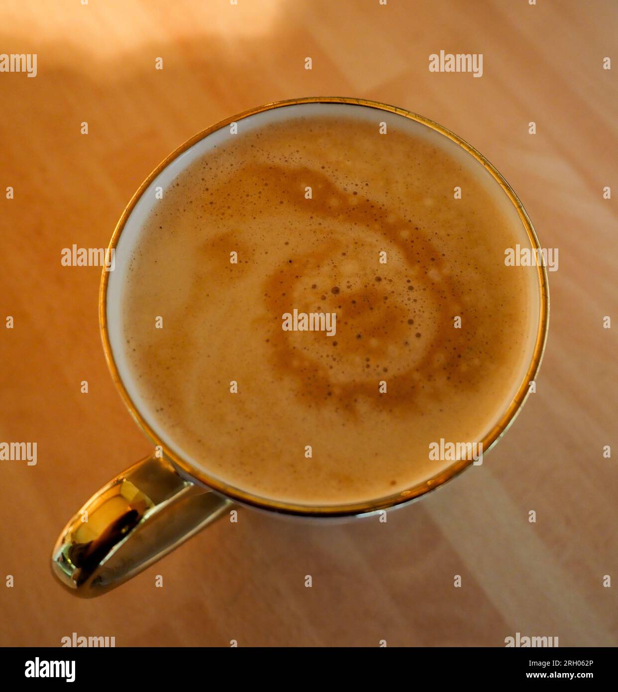 a latte coffee with a swirl pattern in the milk froth Stock Photo - Alamy