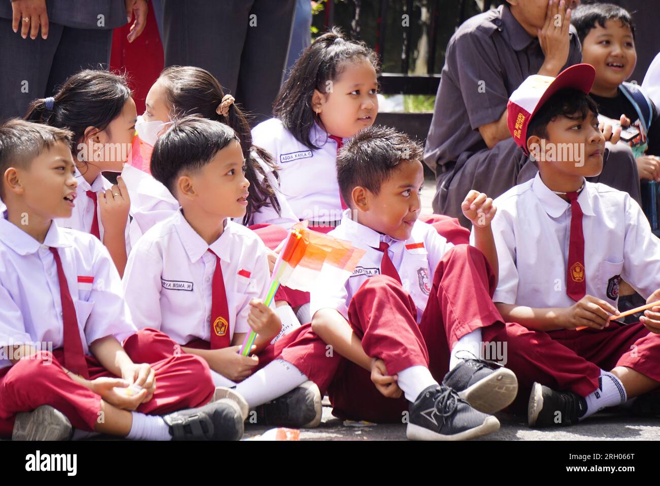 Indonesian elementary school students with their friends holding red ...