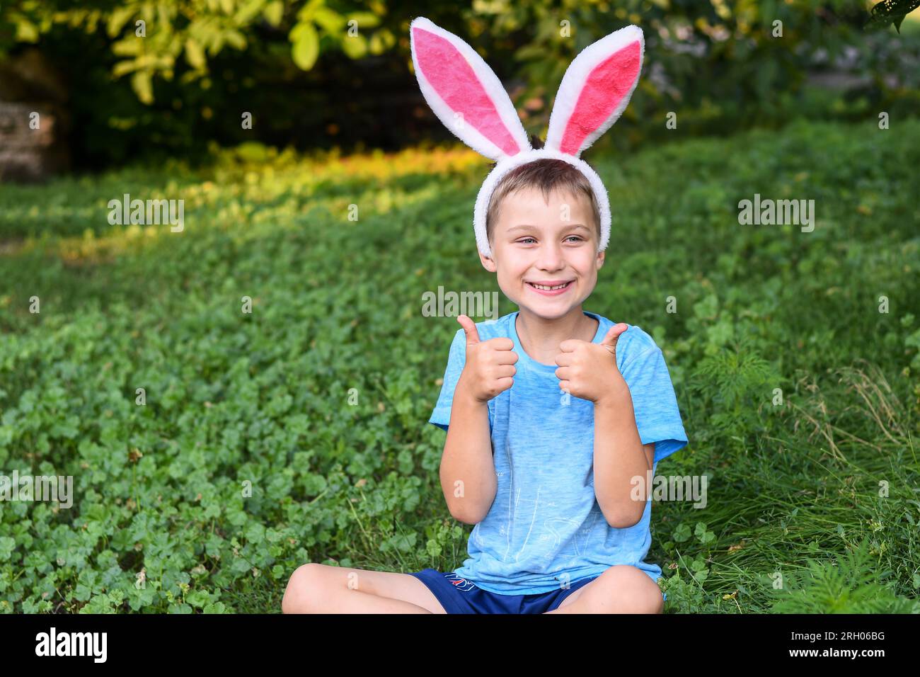 the boy with the ears of a hare gives a thumbs up Stock Photo - Alamy