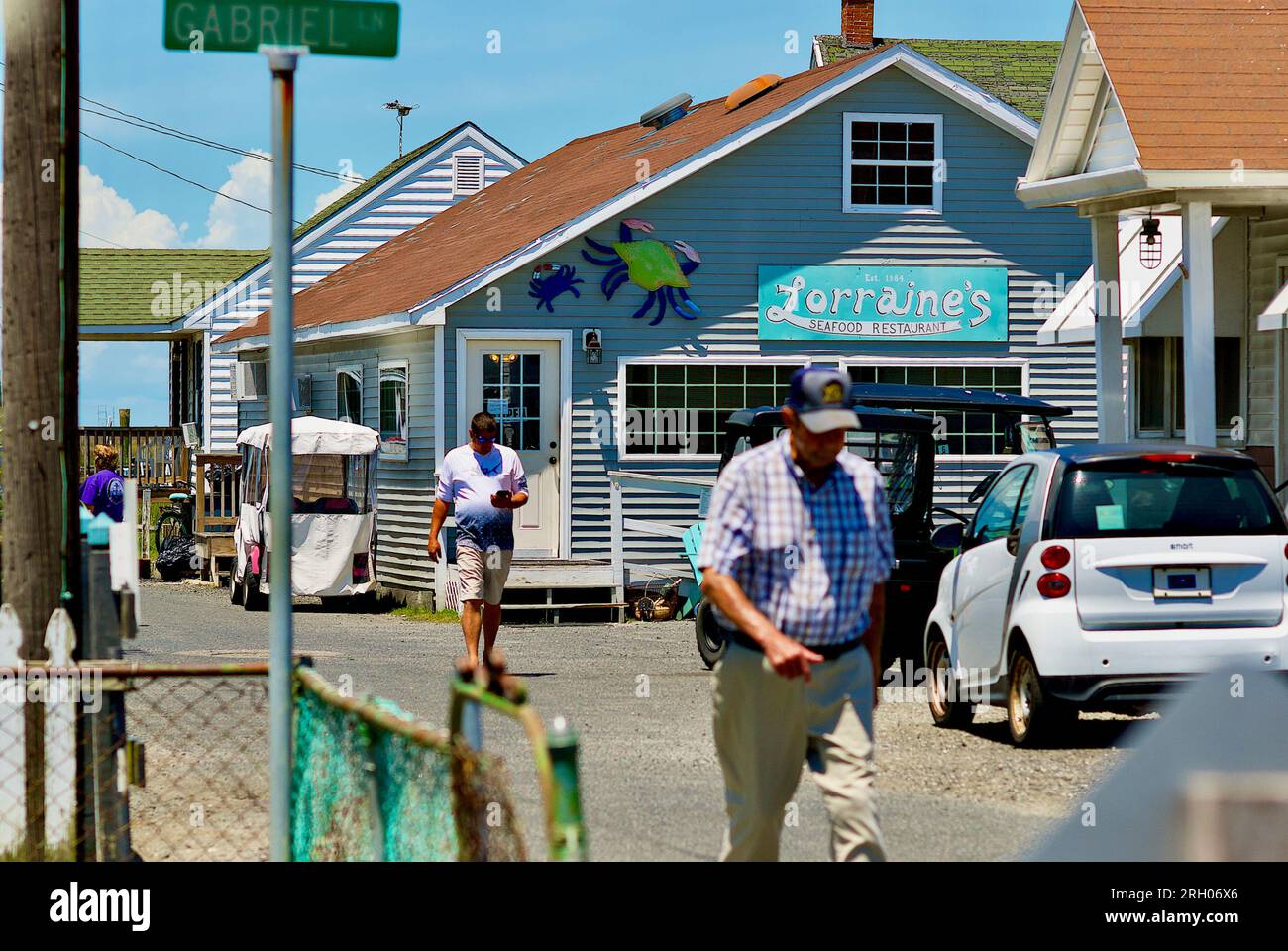 Tangier Island, Virginia, USA - June 21, 2020: People walk past ...