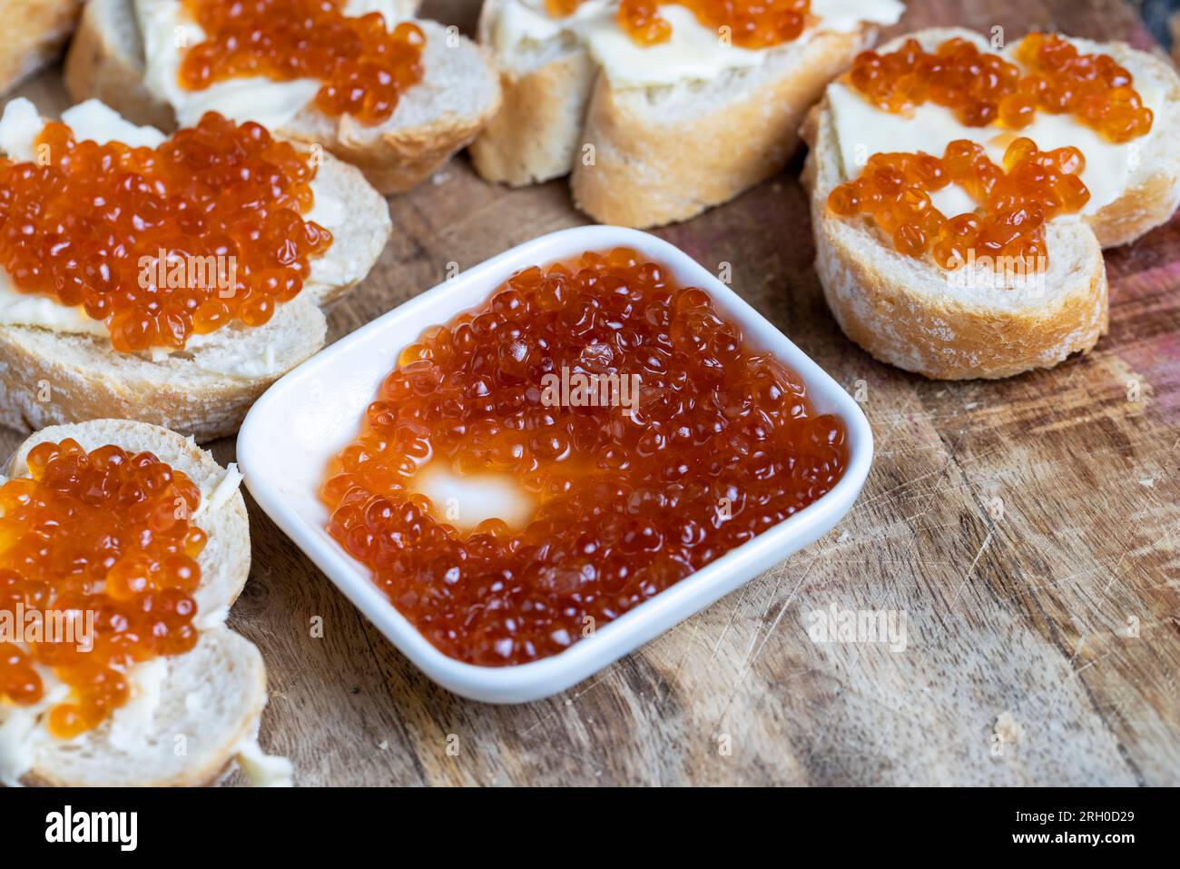 natural red salmon caviar with baguette and butter, making sandwiches ...