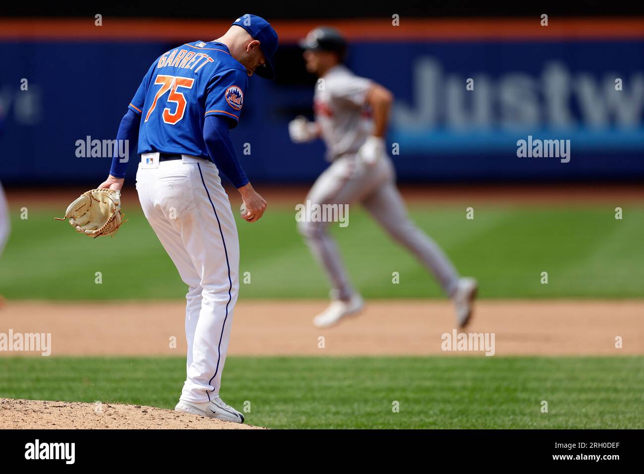 New York Mets pitcher Reed Garrett reacts after giving up a home run to ...