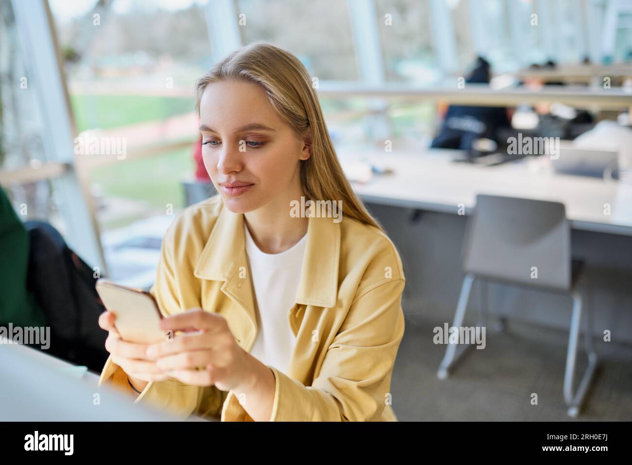 Teen girl gen z student using cell phone looking at smartphone in ...