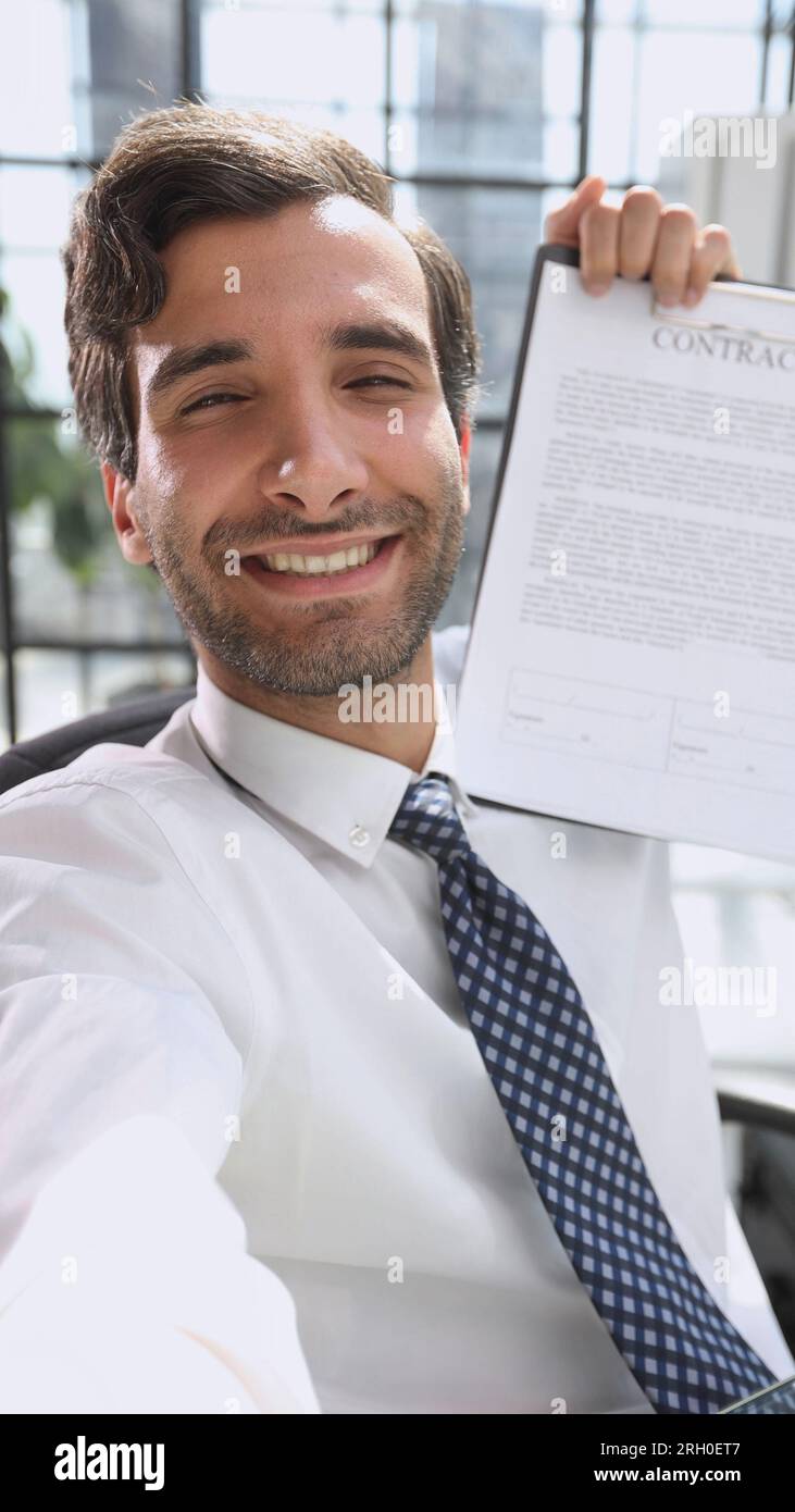 man in white shirt showing contract close up Stock Photo - Alamy