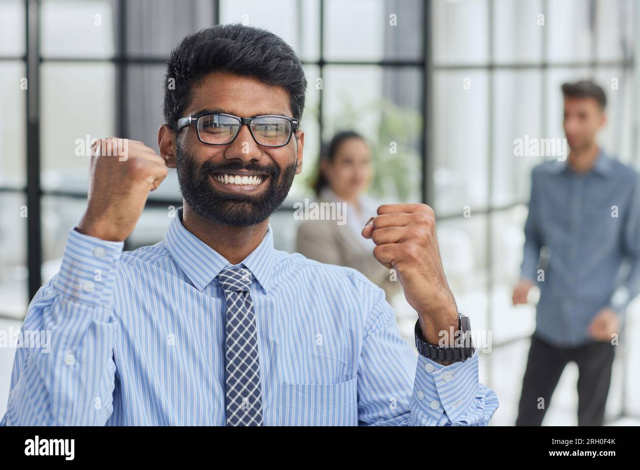 a man holding his hand up a gesture of triumph and victory Stock Photo ...
