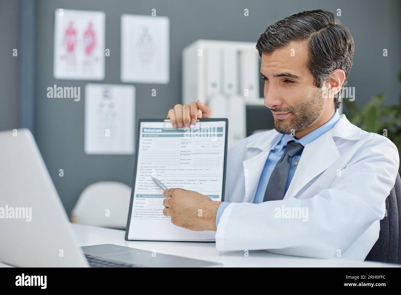 Close up of a doctor and patient hands while phisician pointing into ...
