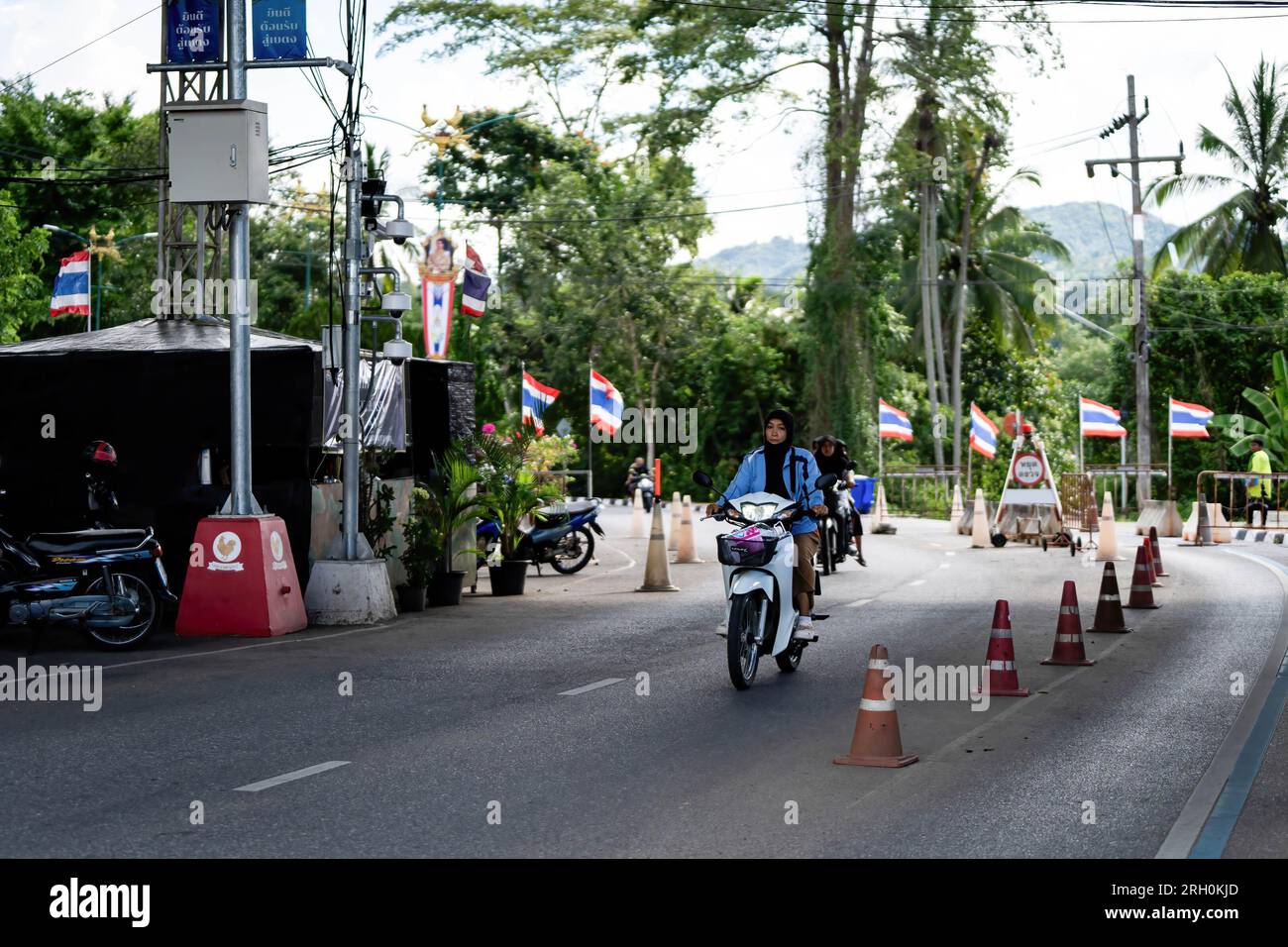 Someone passes through an armed checkpoint in Betong. Daily life in ...