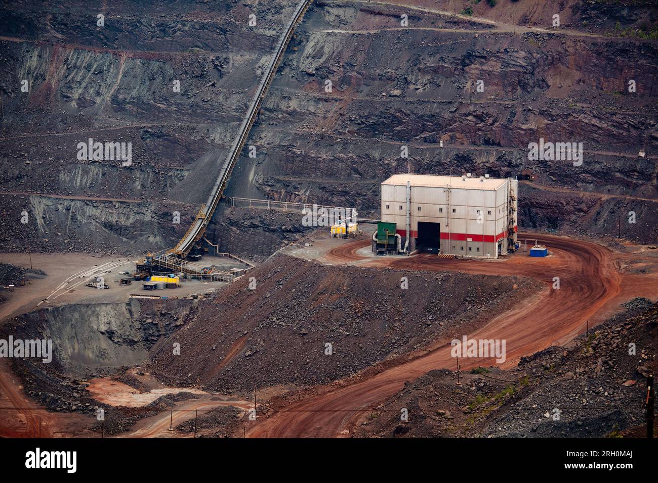 Large conveyor belt in open pit mine for ore transportation Stock Photo ...