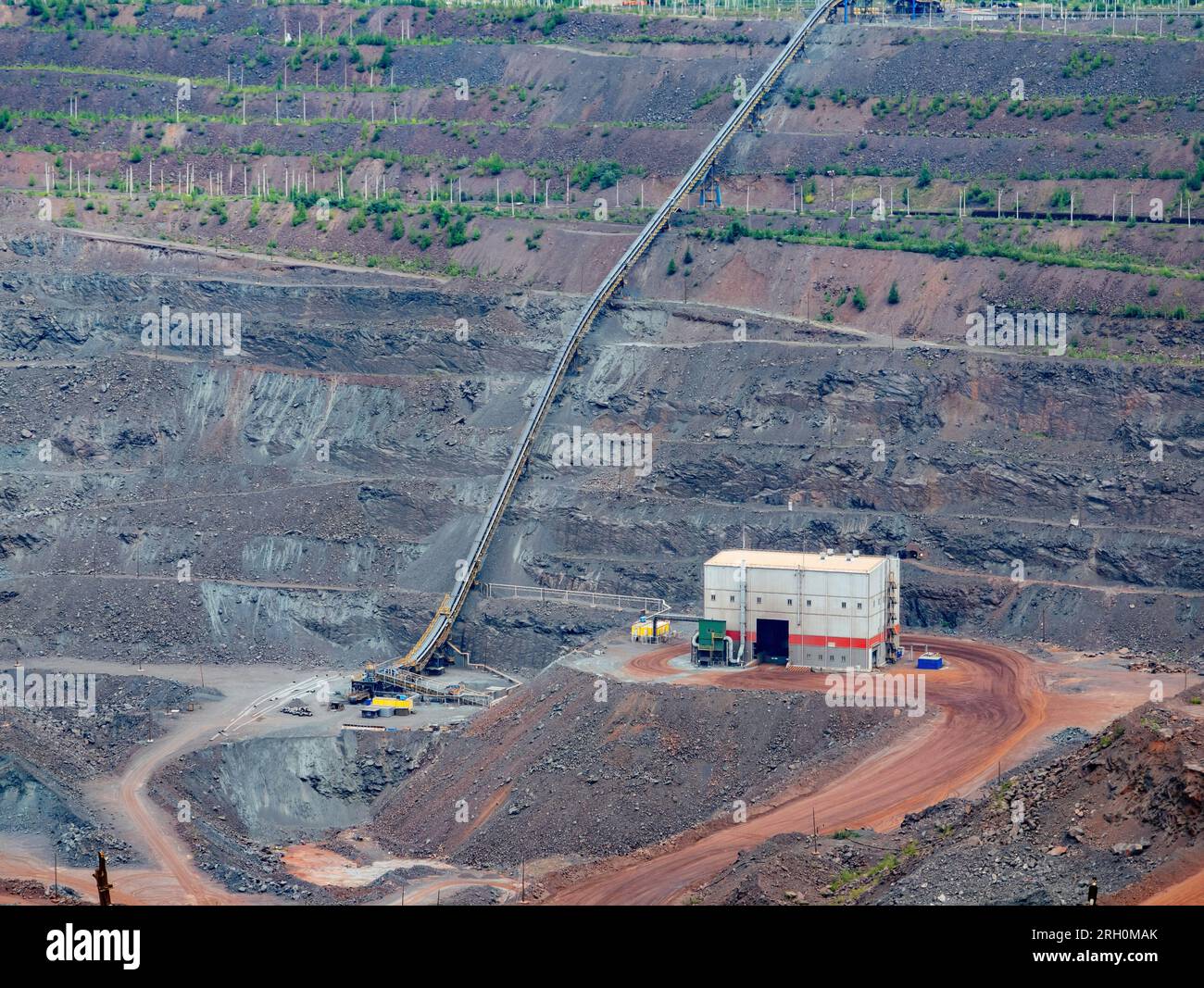 Large conveyor belt in open pit mine for ore transportation Stock Photo ...
