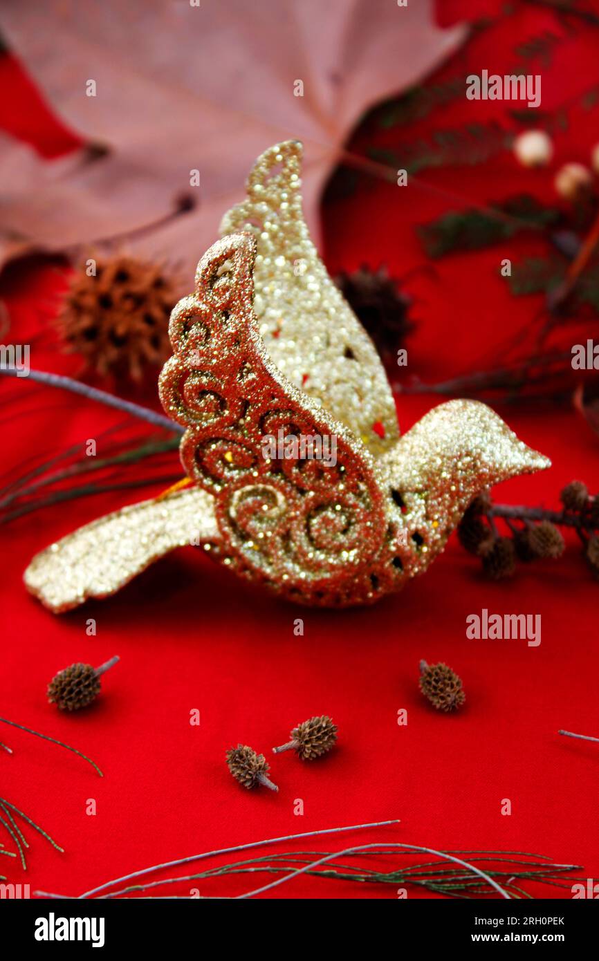 Golden dove, christmas decoration with background of dry leaves and ...