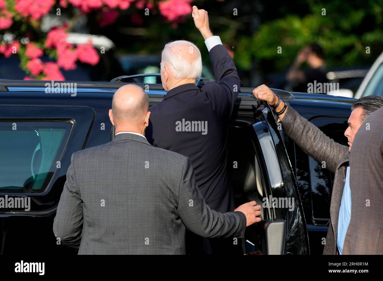 President Joe Biden gestures as he gets into his motorcade after ...