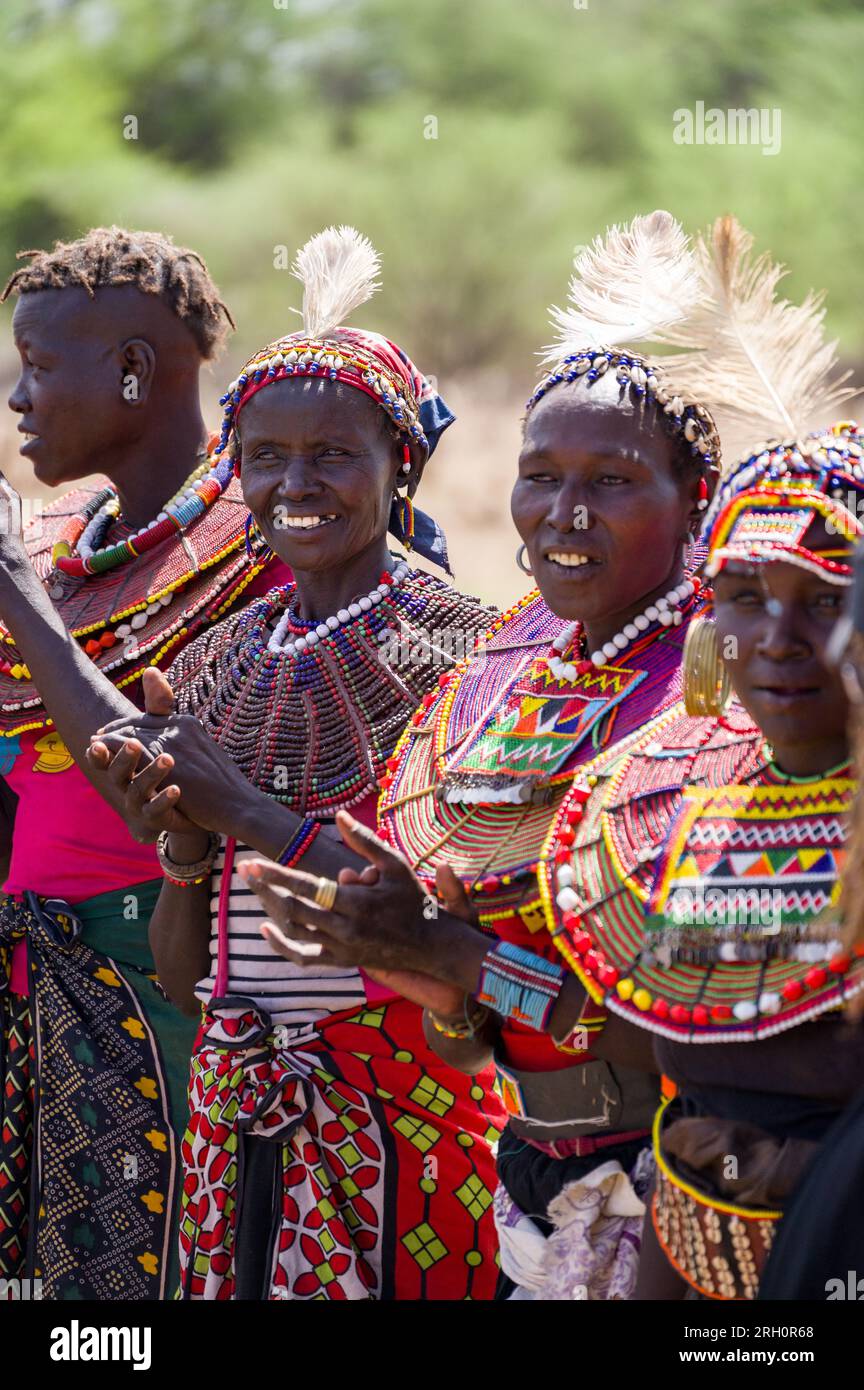 A group of Pokot women in traditional dress singing and dancing, Kenya ...