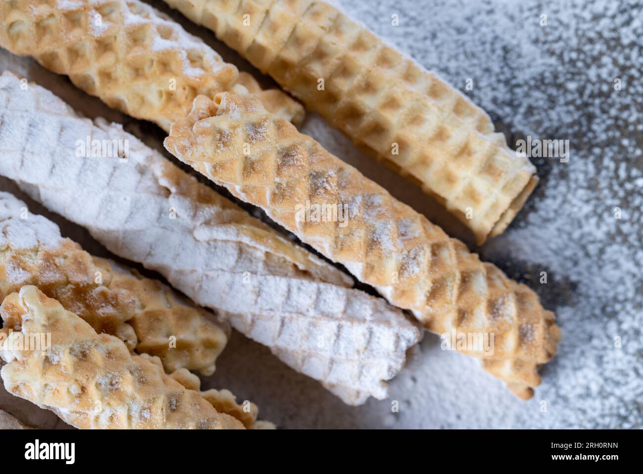 thin crispy waffles lie on a black table, sweet food for desserts Stock ...
