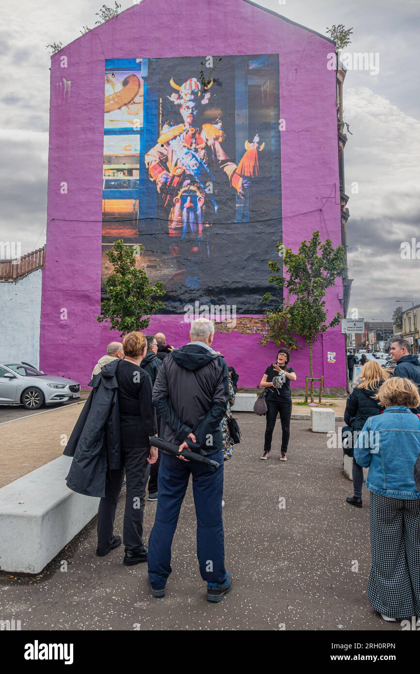 Glasgow Music City Tour group listening to a guide explaining the mural ...