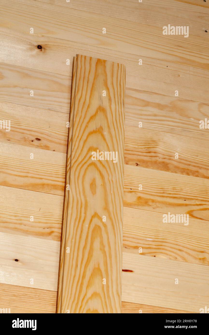 yellow-orange pine wood board during construction works, construction ...