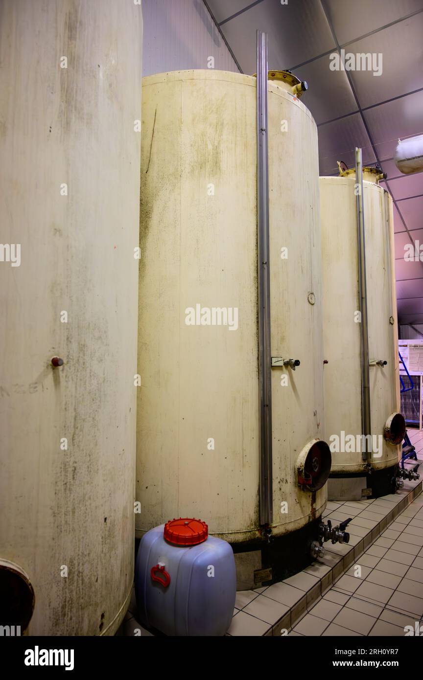 Concrete tanks for fermentation process. Visit of undergrounds caves ...