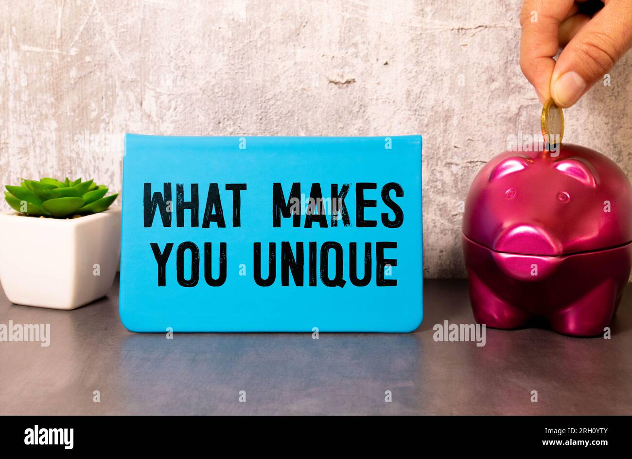 What makes you unique text and alarm clock on white brick wall and ...