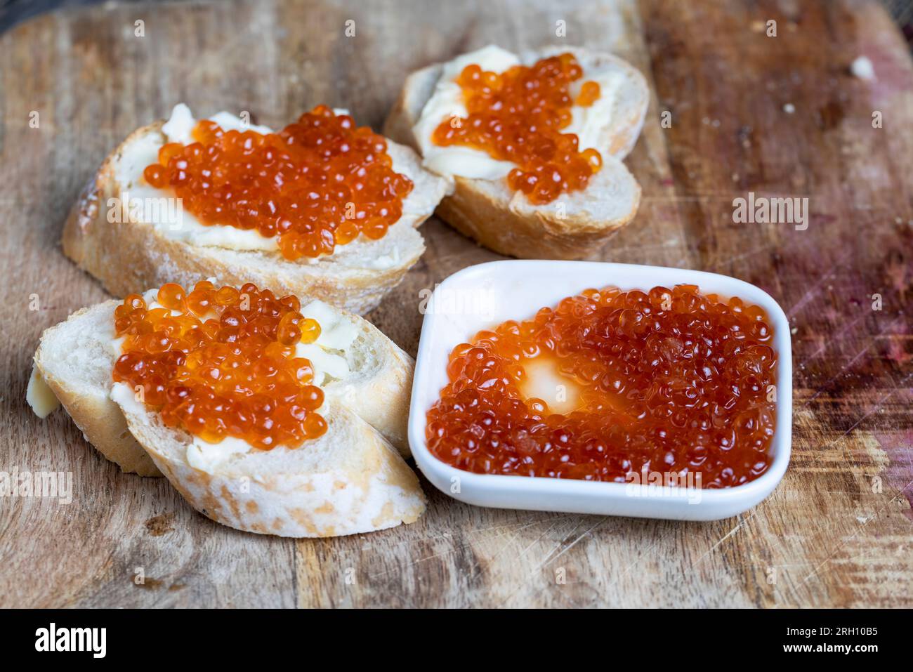 natural red salmon caviar with baguette and butter, making sandwiches ...