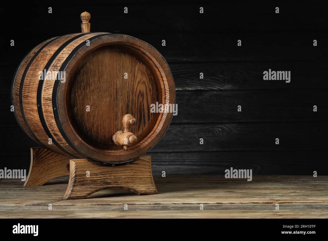 Wooden barrel with tap on table, space for text Stock Photo - Alamy