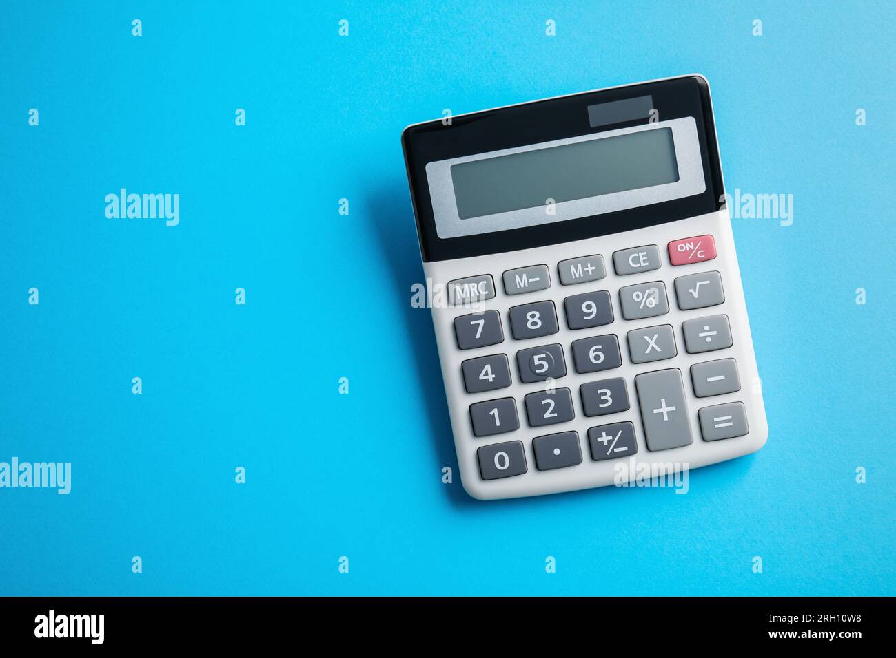 Calculator on light blue background, top view. Space for text Stock ...
