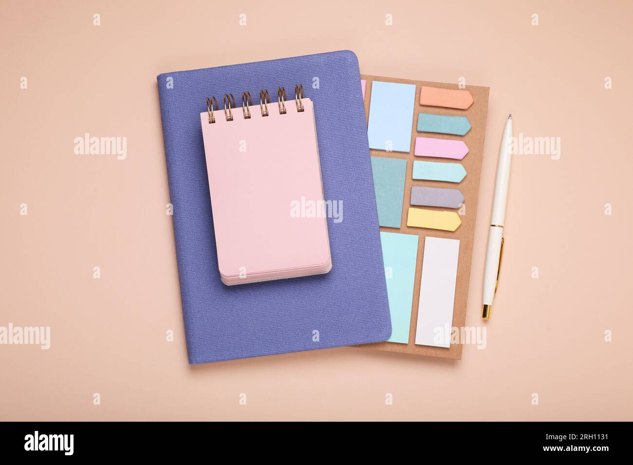 Blank notebook, planner and stationery on beige background, flat lay ...