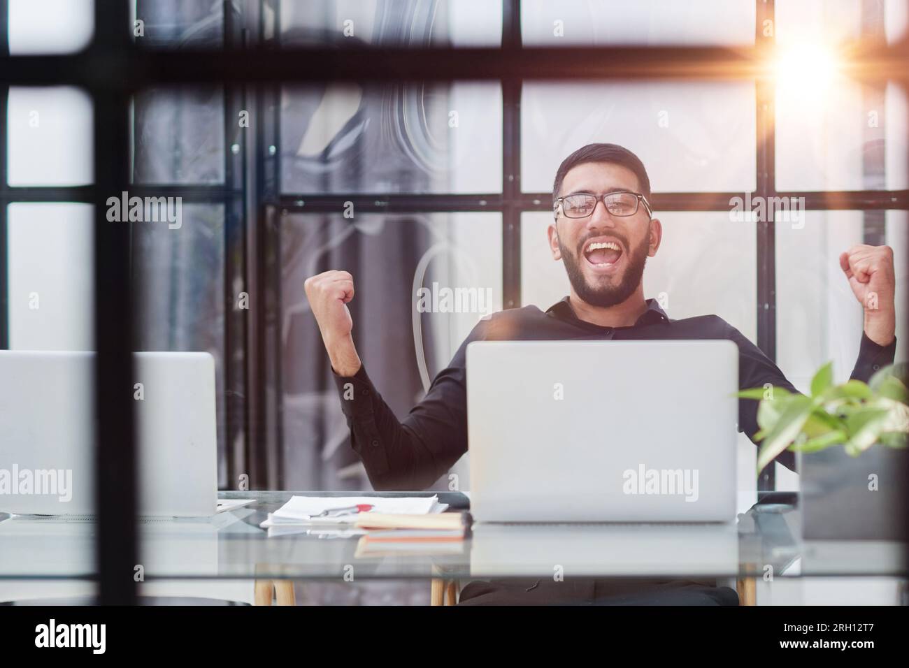 Business man sitting at his desk in the office Stock Photo - Alamy